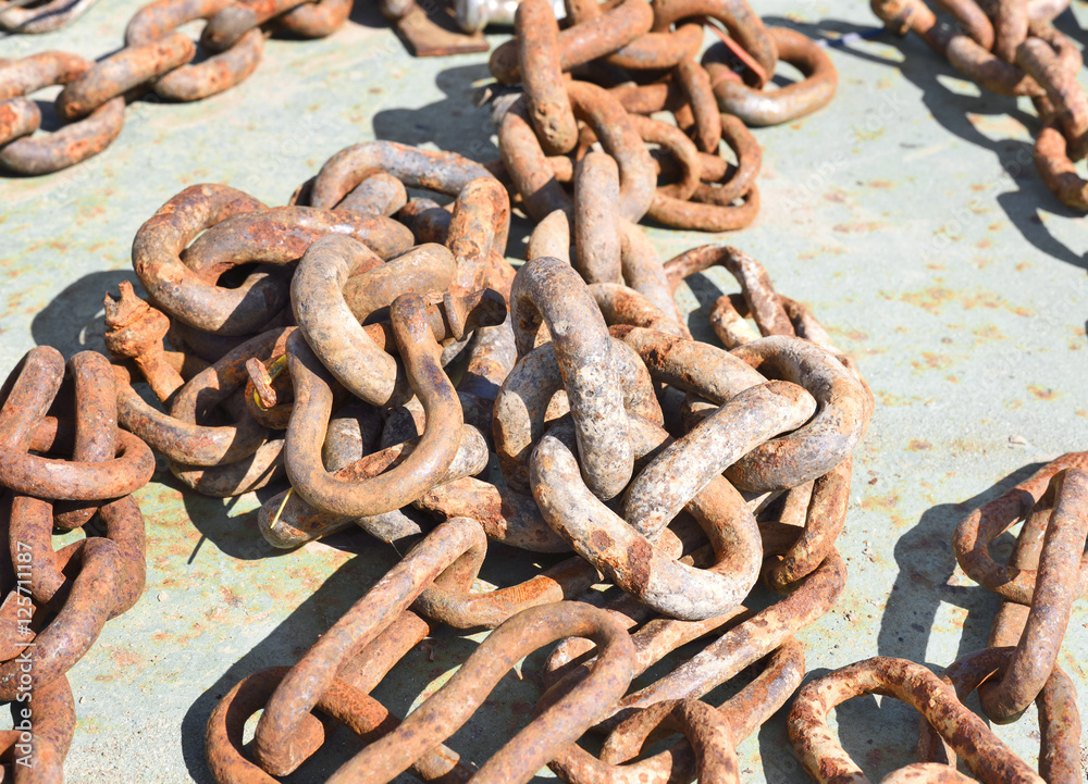 Rusty chain on a boat deck. Stock Photo | Adobe Stock