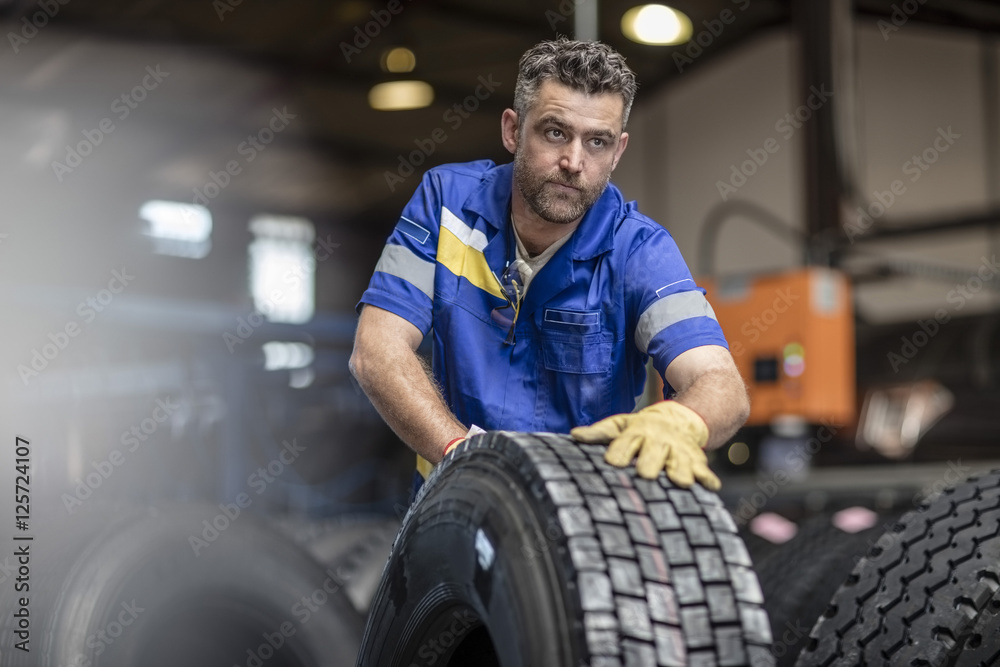 Repairman working in tire factory Stock-Foto | Adobe Stock