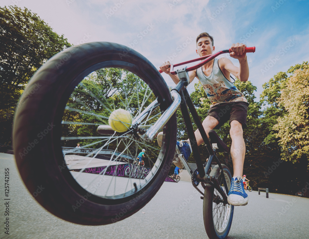 Boy riding a bmx in a park. Stock Photo | Adobe Stock