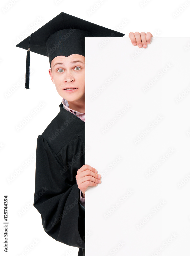Male graduate student peeking from behind a blank panel. Portrait of ...