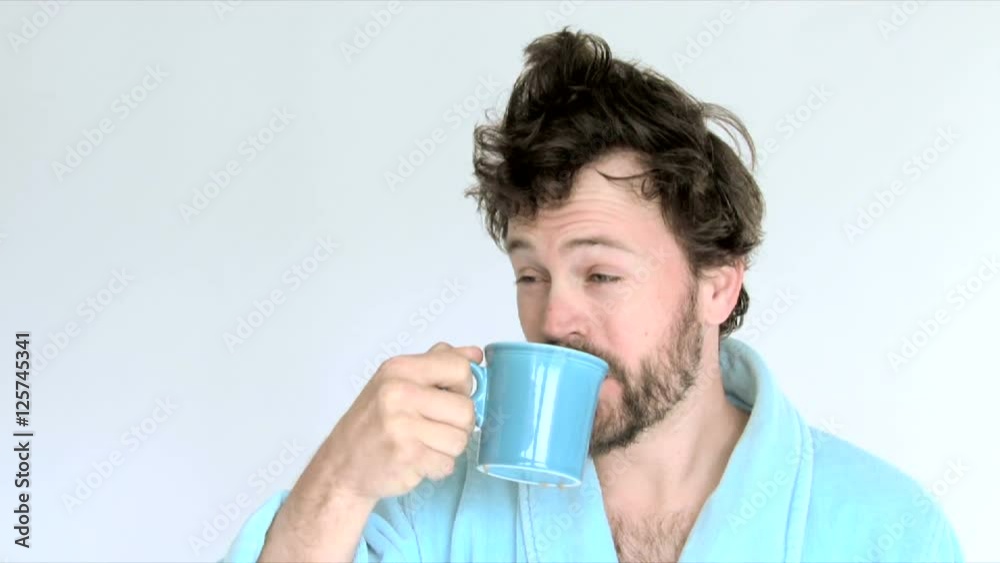 Model released man in studio wearing blue robe drinking coffee in the ...
