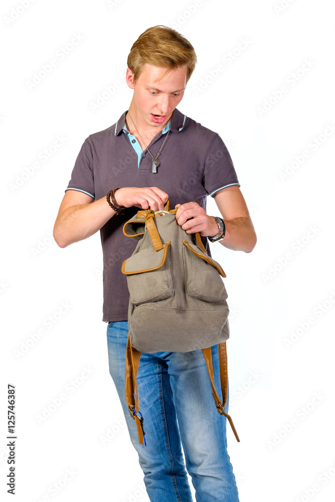 Young man looking for something inside his backpack isolated on white ...