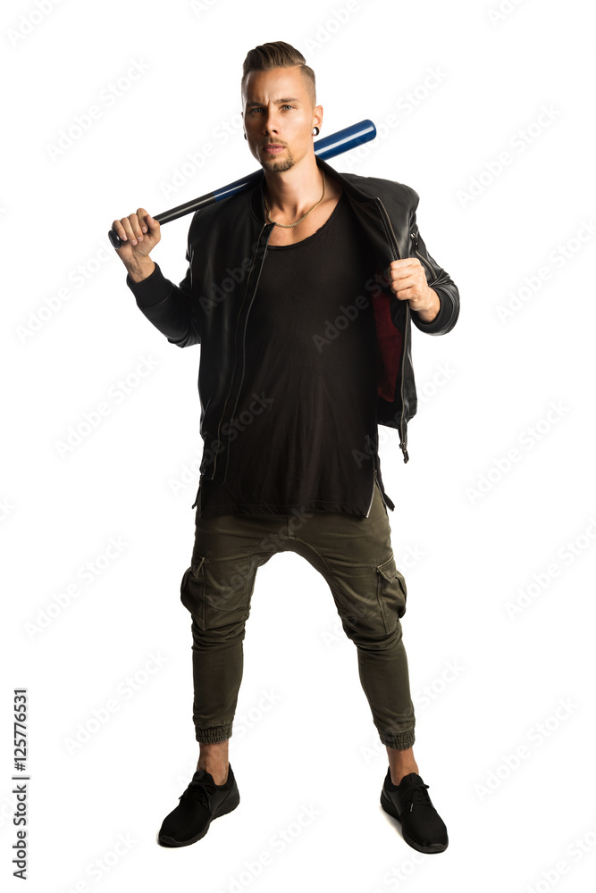 Tough macho man wearing a black leather jacket, standing against a ...