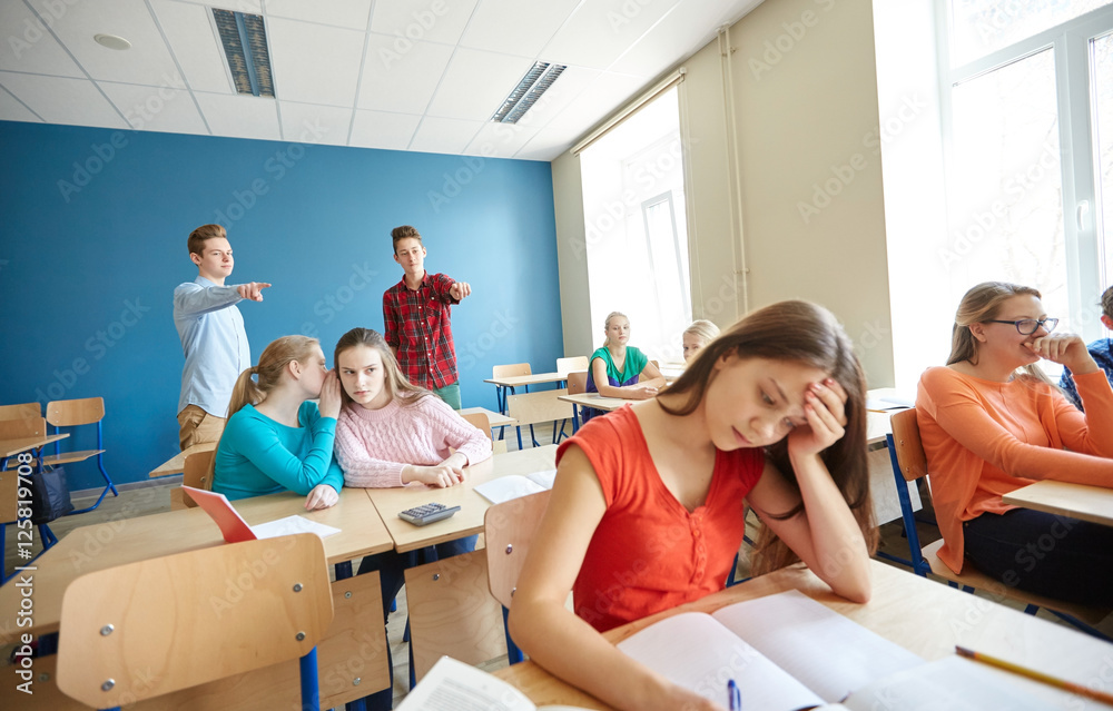 students gossiping behind classmate back at school Stock Photo | Adobe ...