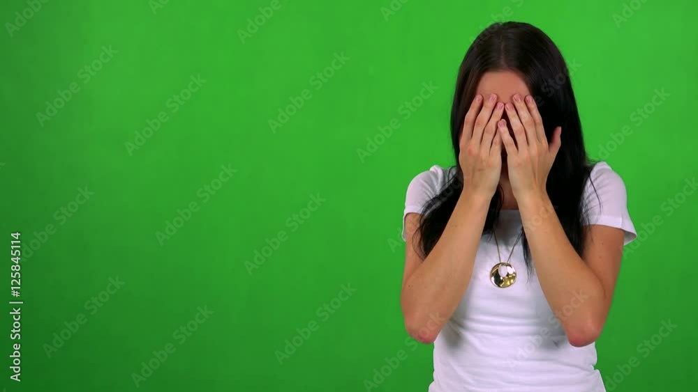young pretty woman cries - green screen - studio Stock Video | Adobe Stock