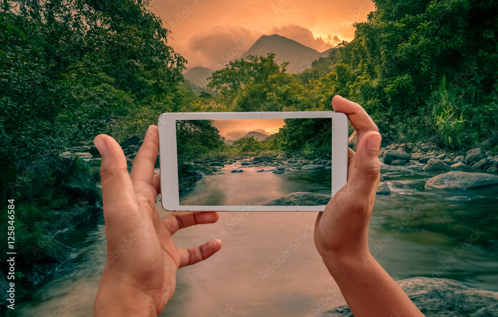 hands holding smart phone for photograph beautiful nature view of river ...