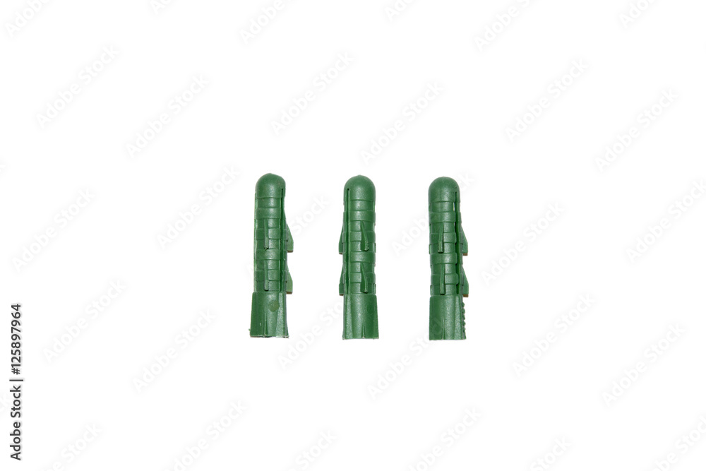 Green building plastic dowel for driving into the wall, isolated on ...