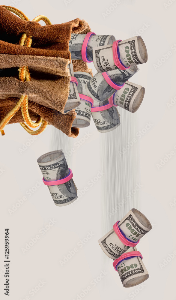 Money falling out of bag. Stock Photo | Adobe Stock