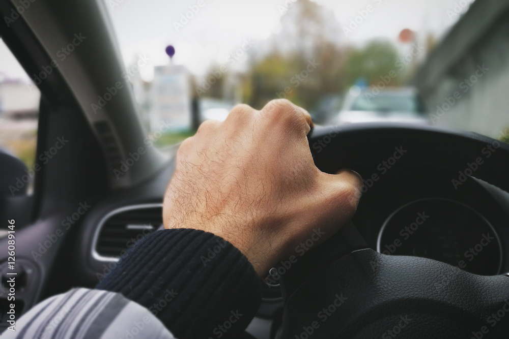 Hand on the wheel driving a car 스톡 사진 | Adobe Stock
