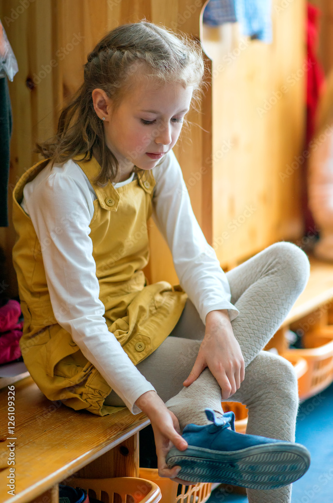 Little girl dressing up in kindergarten. Stock Photo | Adobe Stock