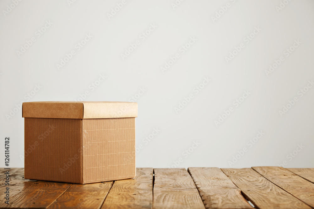 New fancy square corrugated cardboard box with a cover shot on top of a ...
