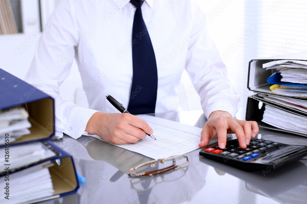 Bookkeeper or female financial inspector making report, calculating or ...