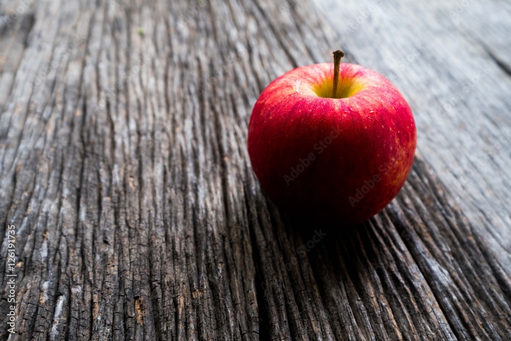 Apple with shadow on wooden background. Stock Photo | Adobe Stock