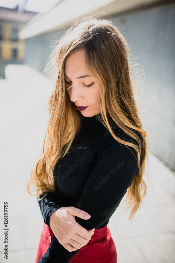 Charming shy girl posing outdoors. Stock Photo | Adobe Stock