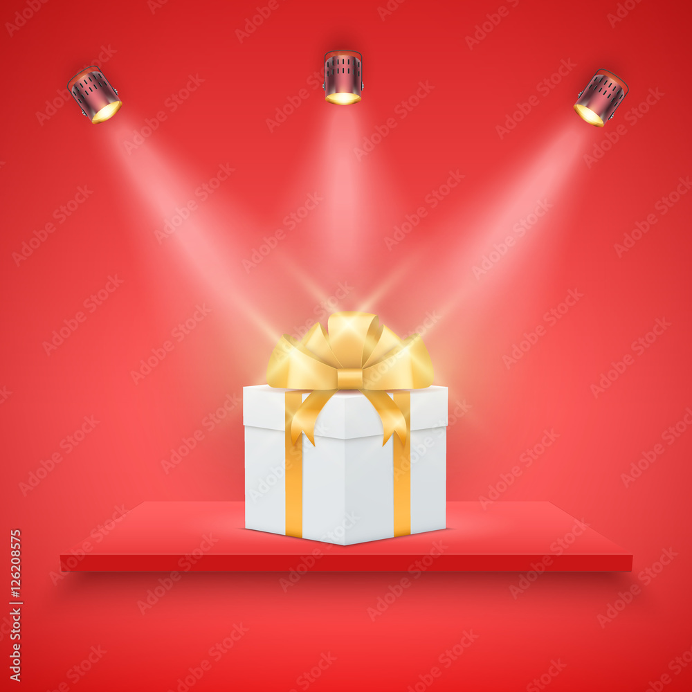 Light box with red platform on red backdrop with spotlights and gift ...
