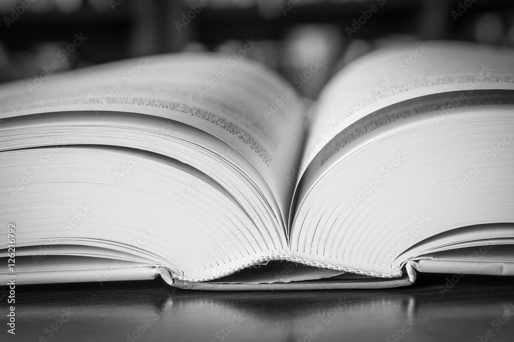 Black and white open book on the table in a library Stock Photo | Adobe ...