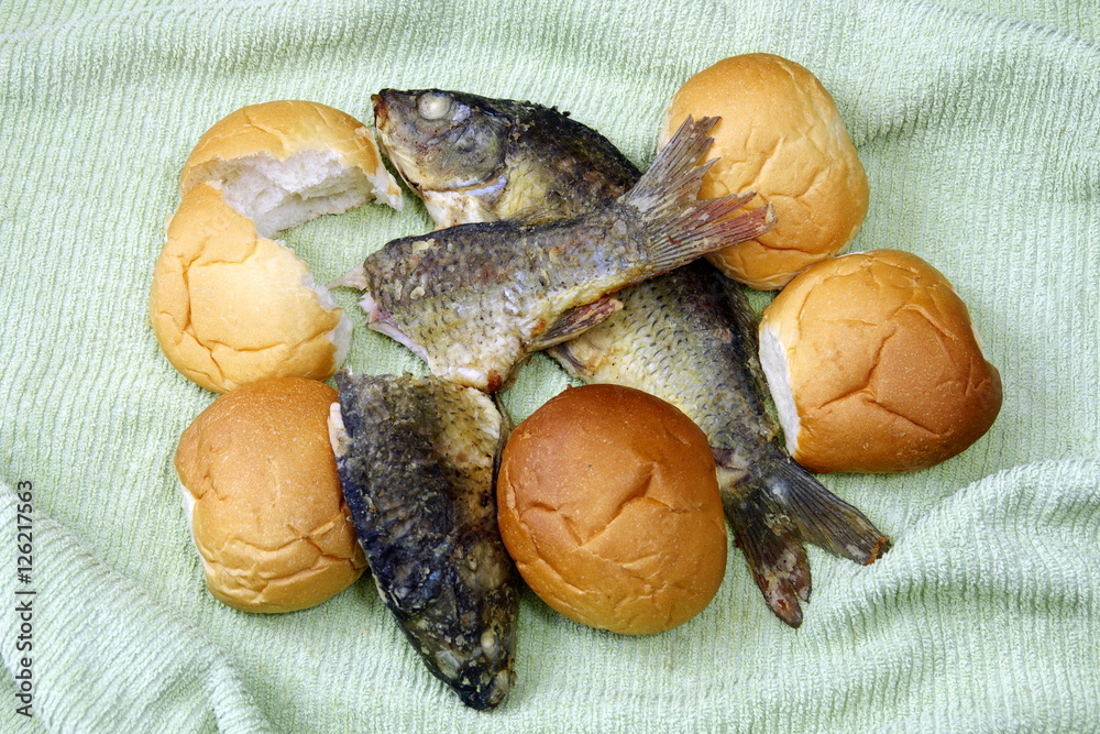 The five loaves, and the two fishes. Stock Photo | Adobe Stock