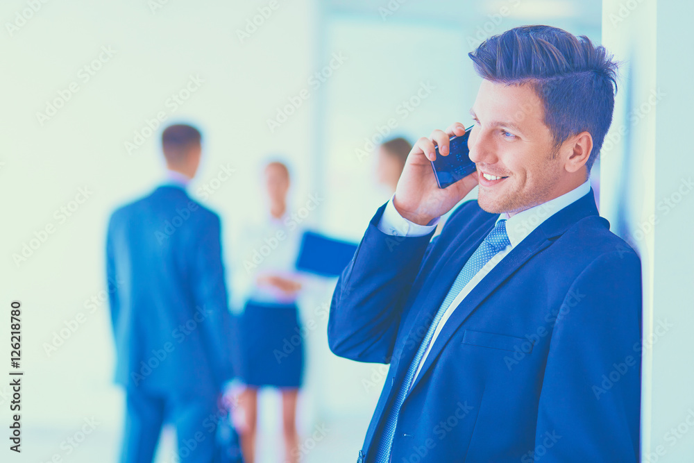 Business man using his mobile phone in office Stock Photo | Adobe Stock