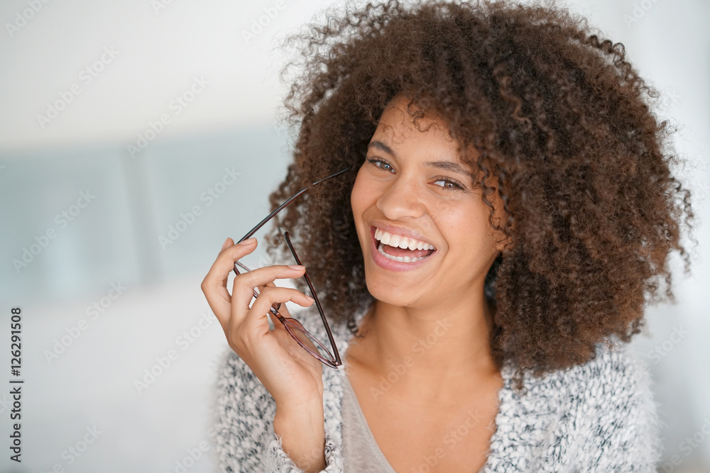 Portrait of attractive and cheerful mixed-race woman with eyeglasses ...