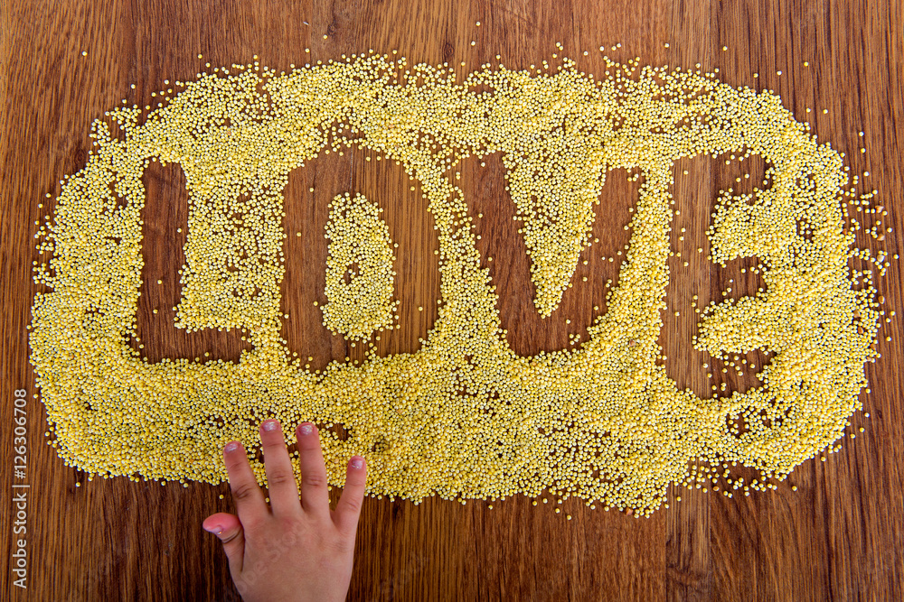Declaration of love painted millet. Child draws on a table with ...