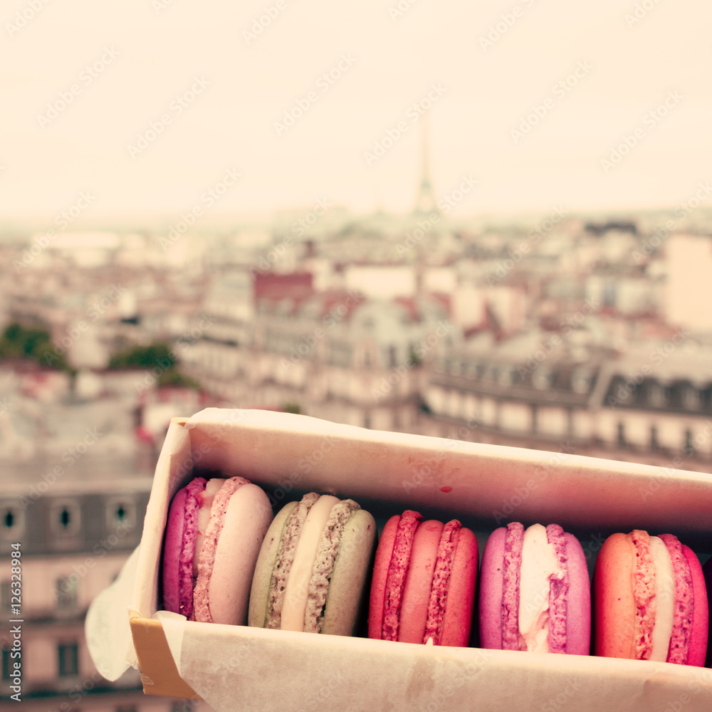 French macarons in a box and Paris skyline Photos | Adobe Stock