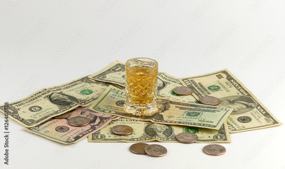 Glass of alcohol drink with money Stock-Foto | Adobe Stock