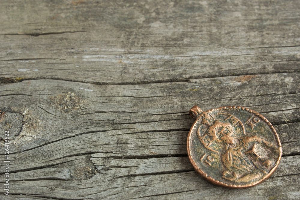 old copper coin pendant with the symbol of saint and cross Stock Photo ...