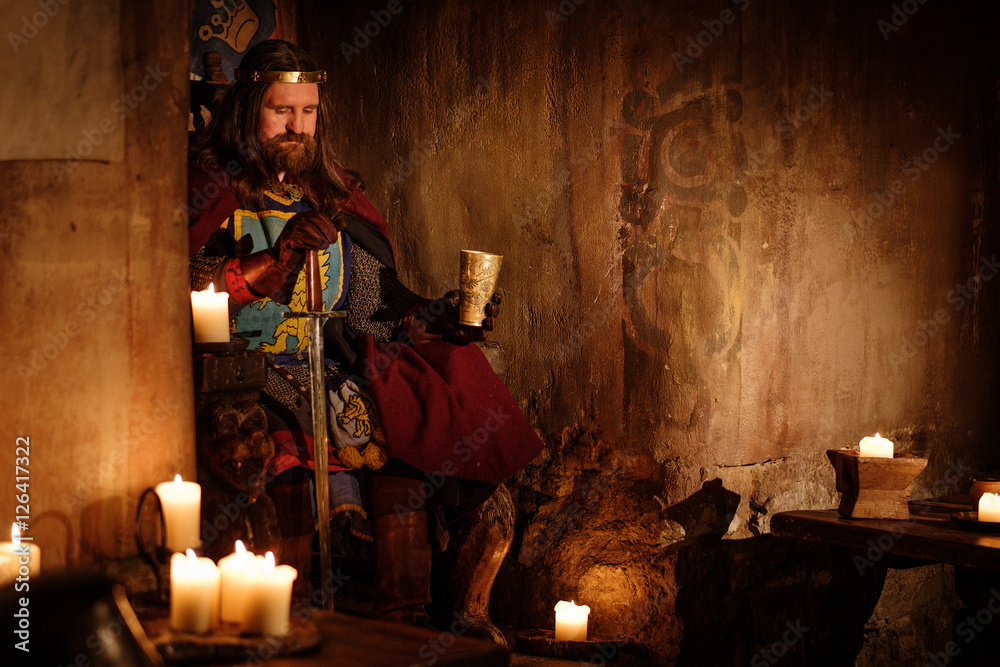 Medieval king on throne in ancient castle interior. Stock Photo | Adobe ...