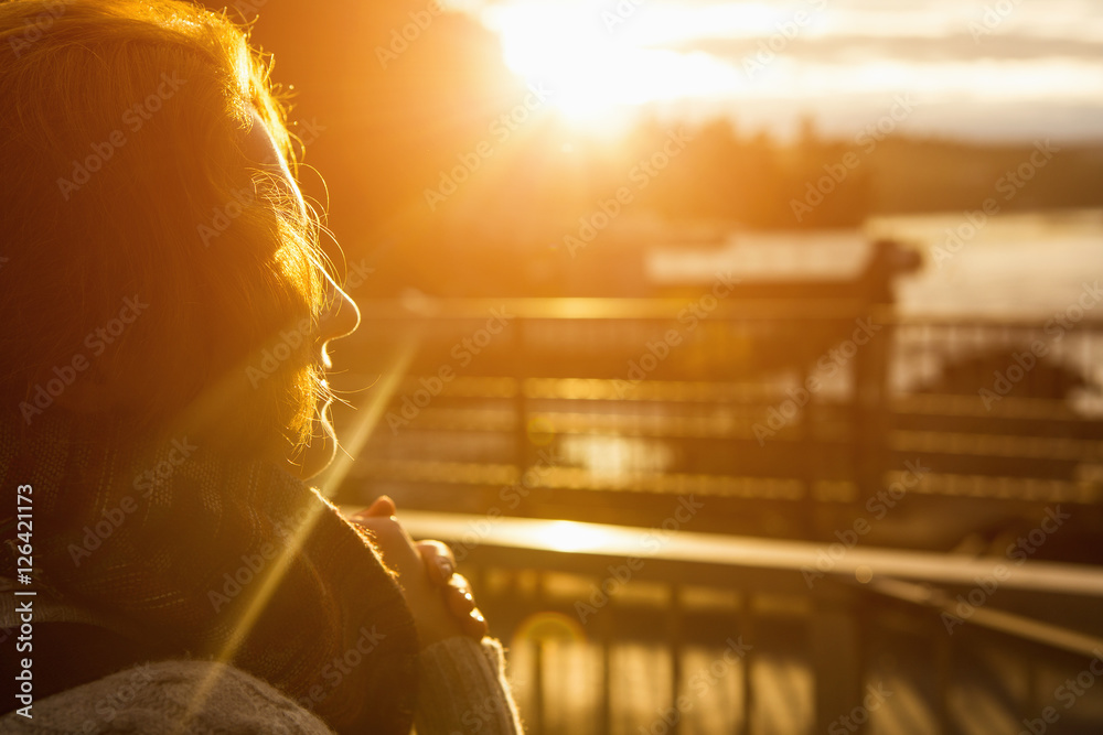 Sad girl looks at the sunset. A girl holding a backpack. Thoughtful ...