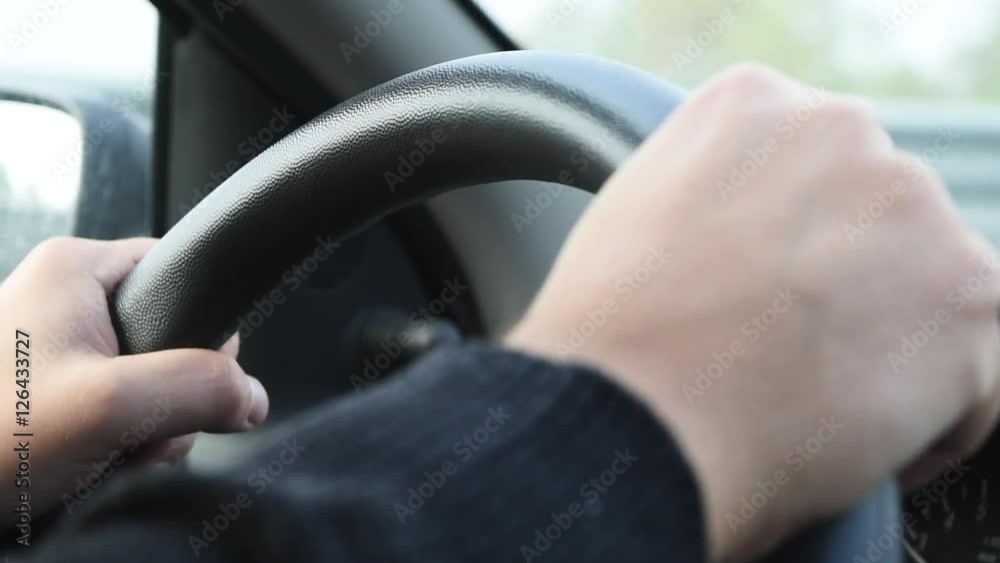 Male arms on a steering wheel while he drives a car Stock ビデオ | Adobe Stock