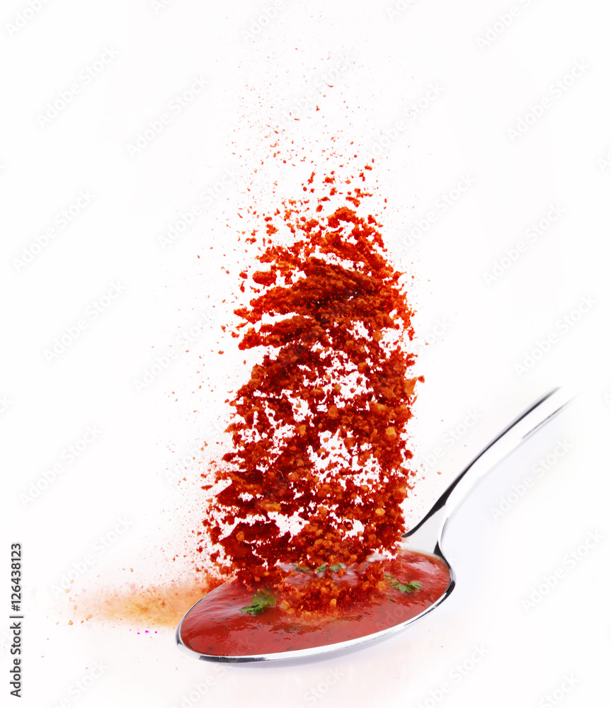 Tomato soup with red powder explosion isolated on white background ...