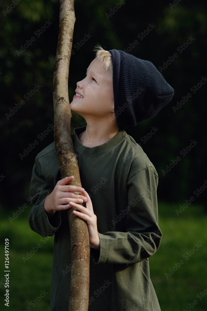 young boy holding big stick Stock Photo | Adobe Stock