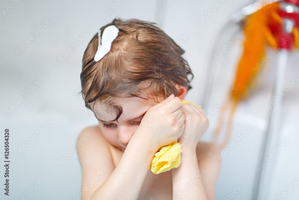 cute little kid boy washing hair in bathtub Stock Photo | Adobe Stock