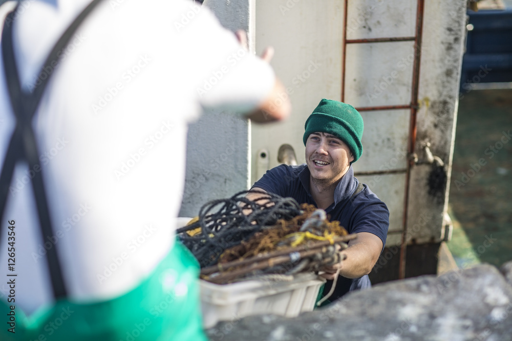 Fishermen working on trawler Stock Photo | Adobe Stock