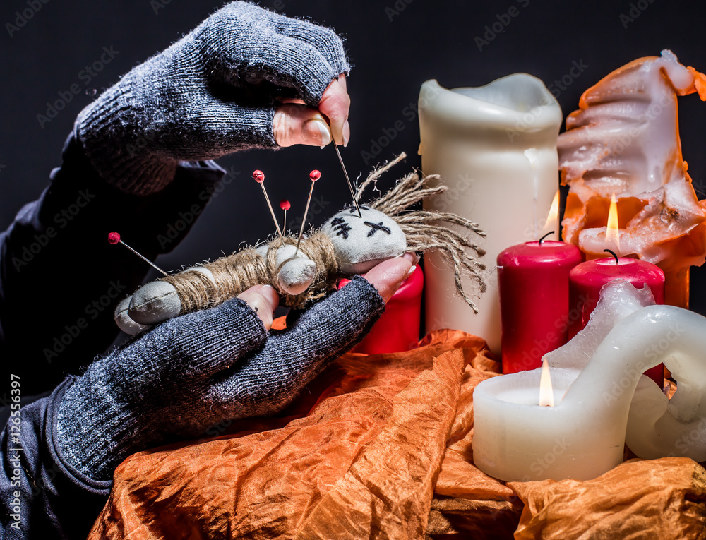In a Voodoo doll are needles pricked Stock Photo | Adobe Stock