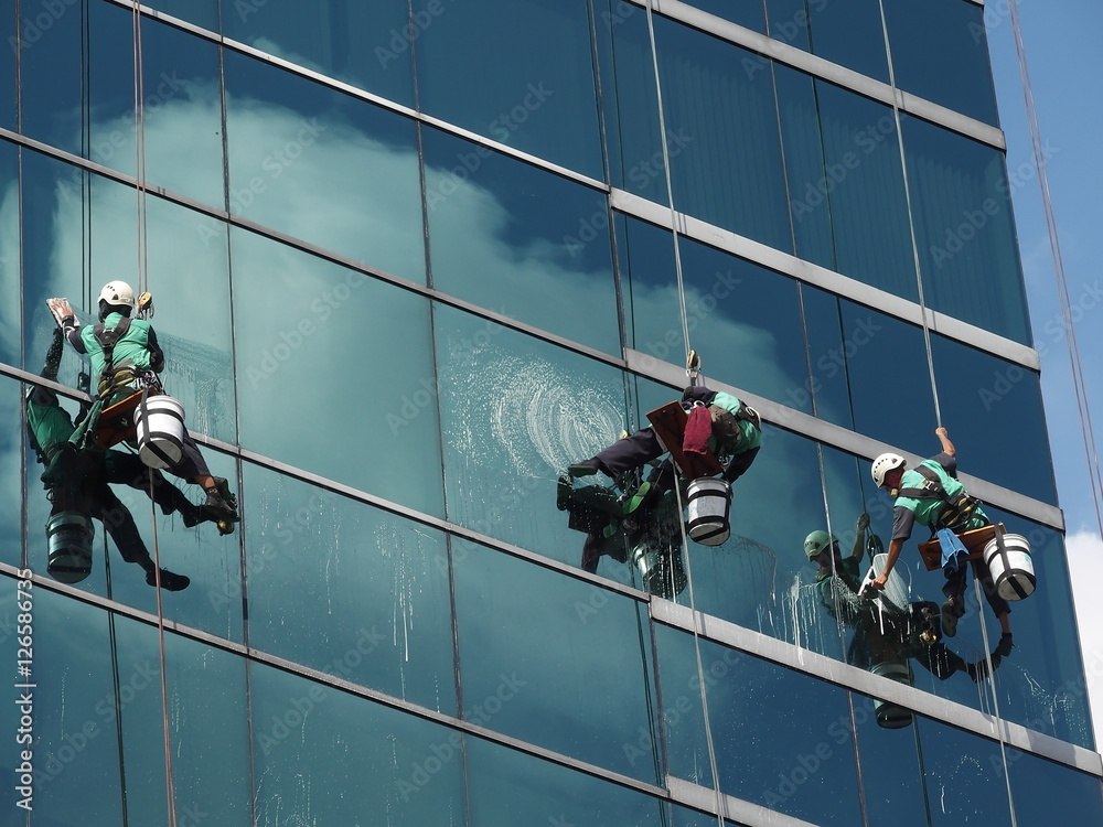 men cleaning glass building by rope access at height Stock Photo ...
