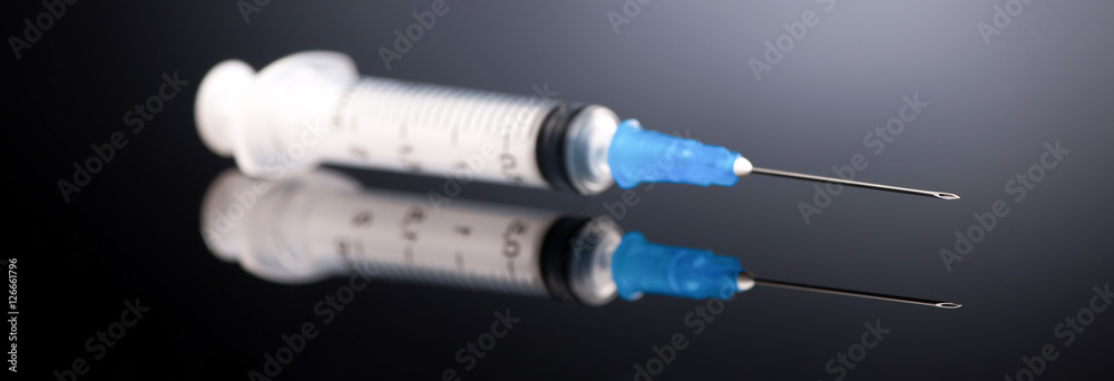 one medical syringe on a dark gray background with reflection Stock ...