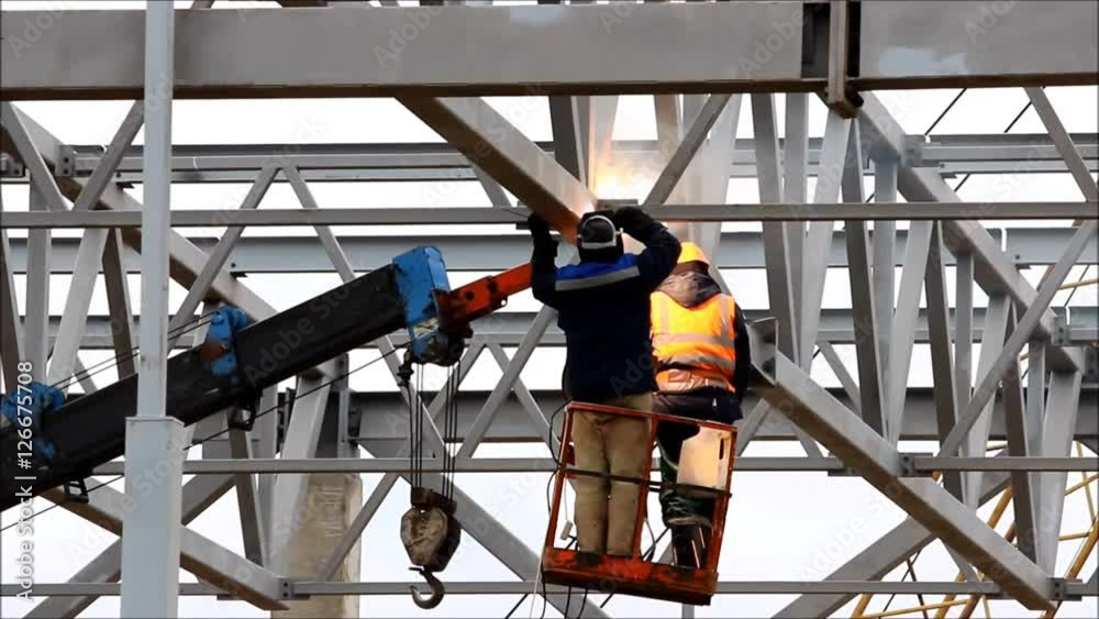 a welder working at height without insurance in a cradle lift in the ...