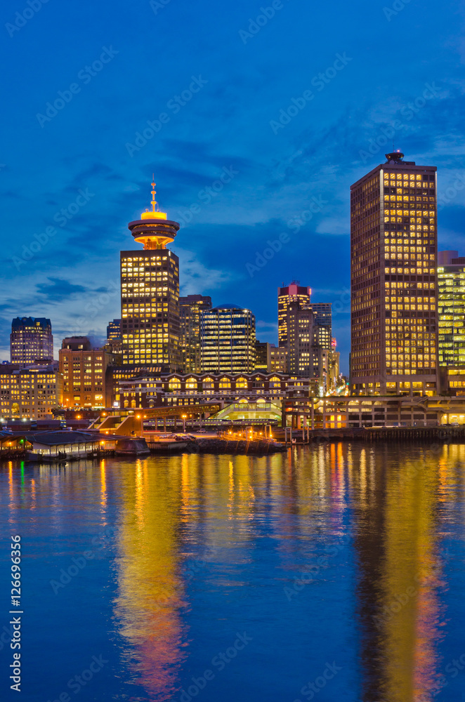 City at night, panoramic scene of downtown reflected in water ...