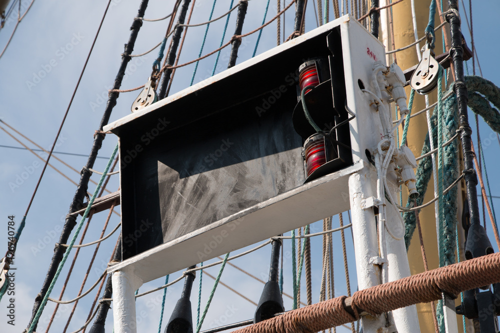 Ship red light of tall ship, mast and ropes in background Stock Photo ...