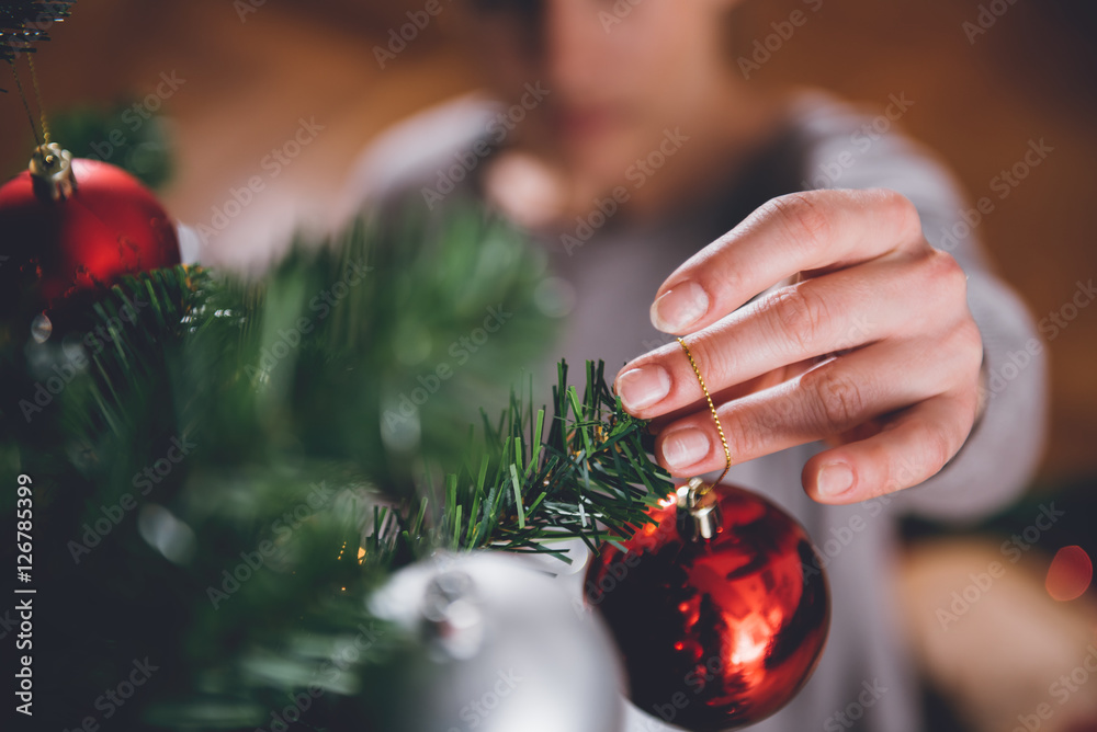 Woman decorating christmas tree Stock Photo | Adobe Stock