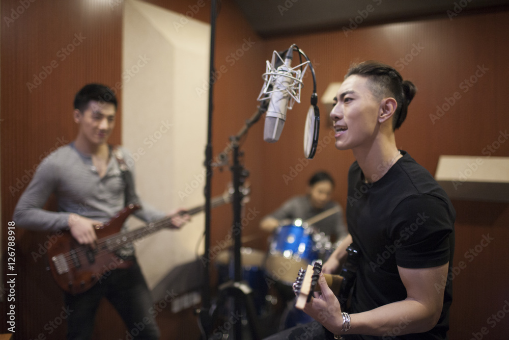 Musical band in recording studio Stock Photo | Adobe Stock