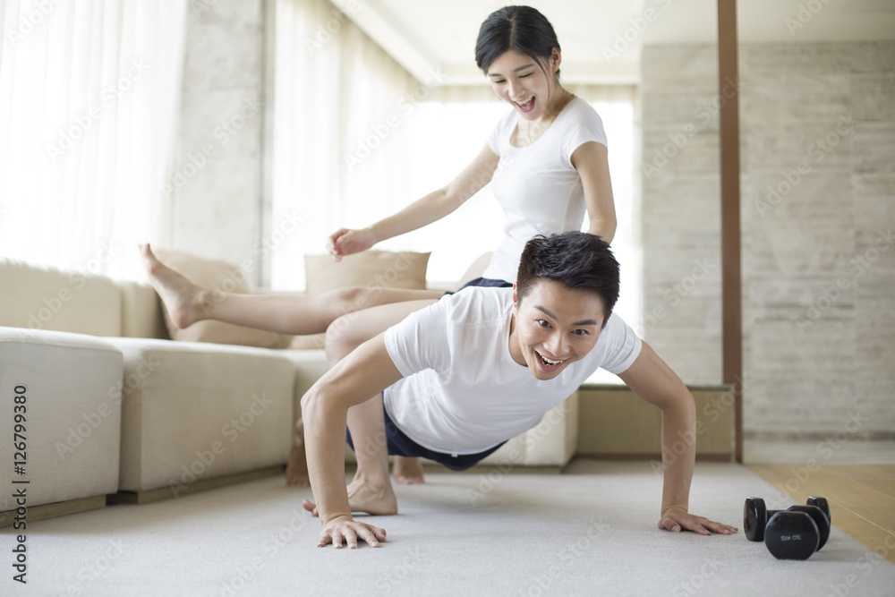 Woman Sitting On Mans Back
