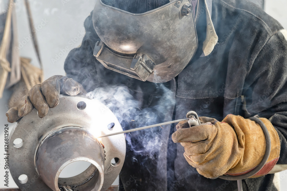 Manual arc welding conical transition with a skirted flange Stock Photo ...