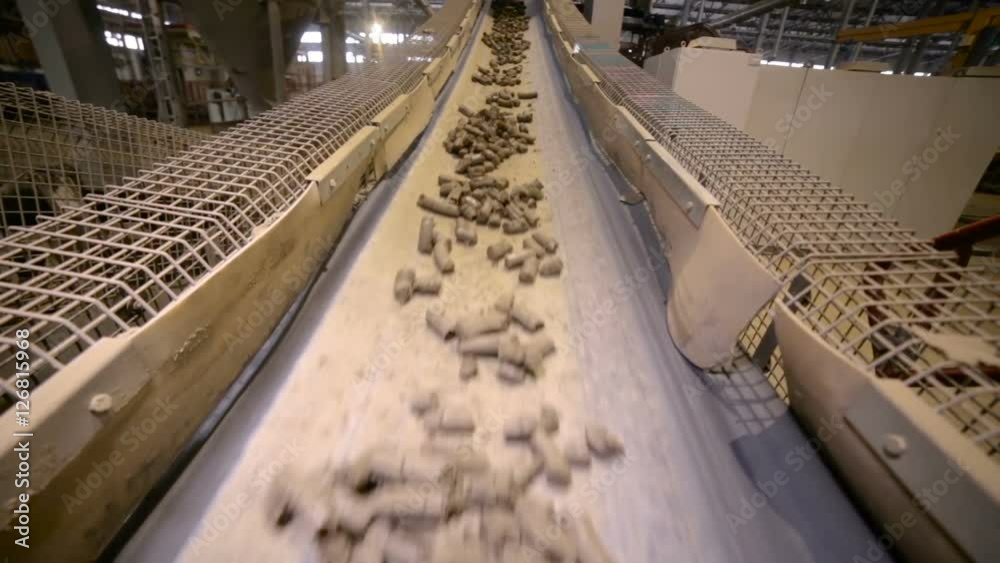 Conveyor with soil. Clay goes through transporter in a mining factory ...