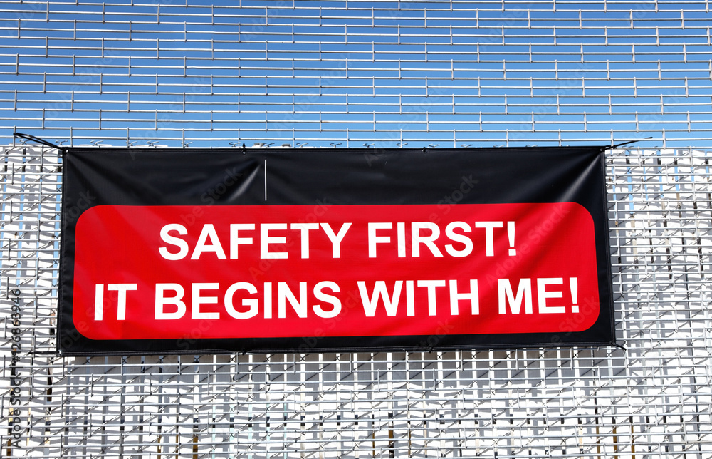 Safety First Sign attached to huge industrial gate entrance. Stock ...