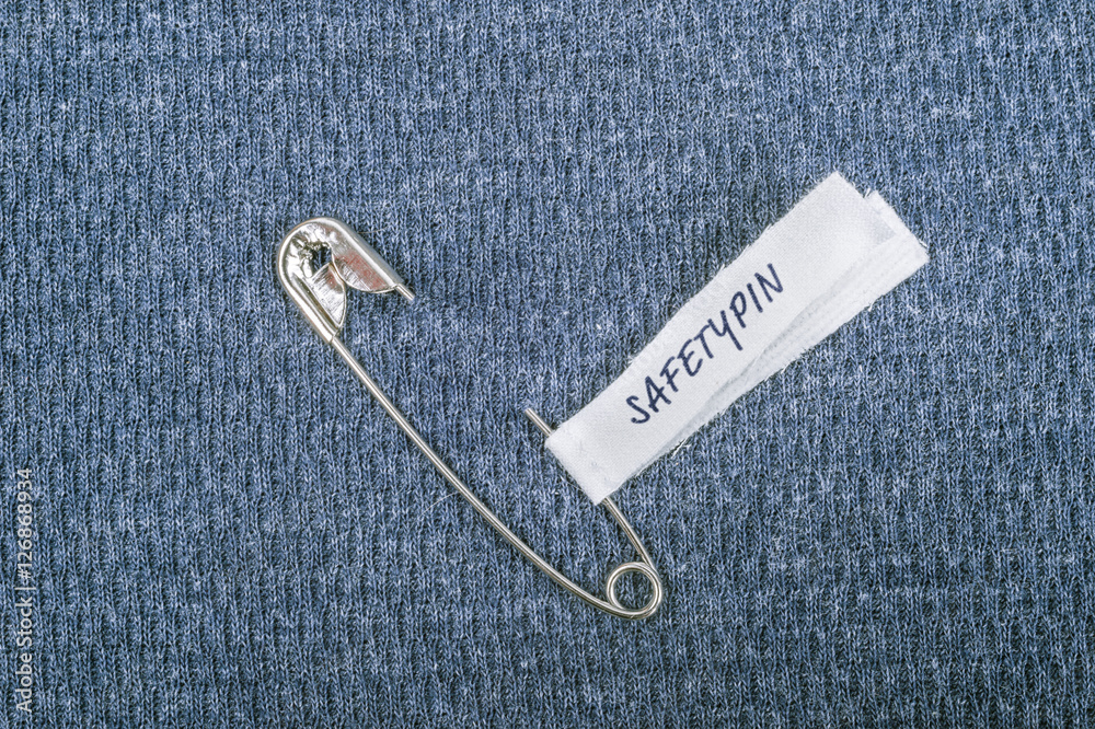 Safety pins on clothes with label "I am a safe place" as a symbol of ...