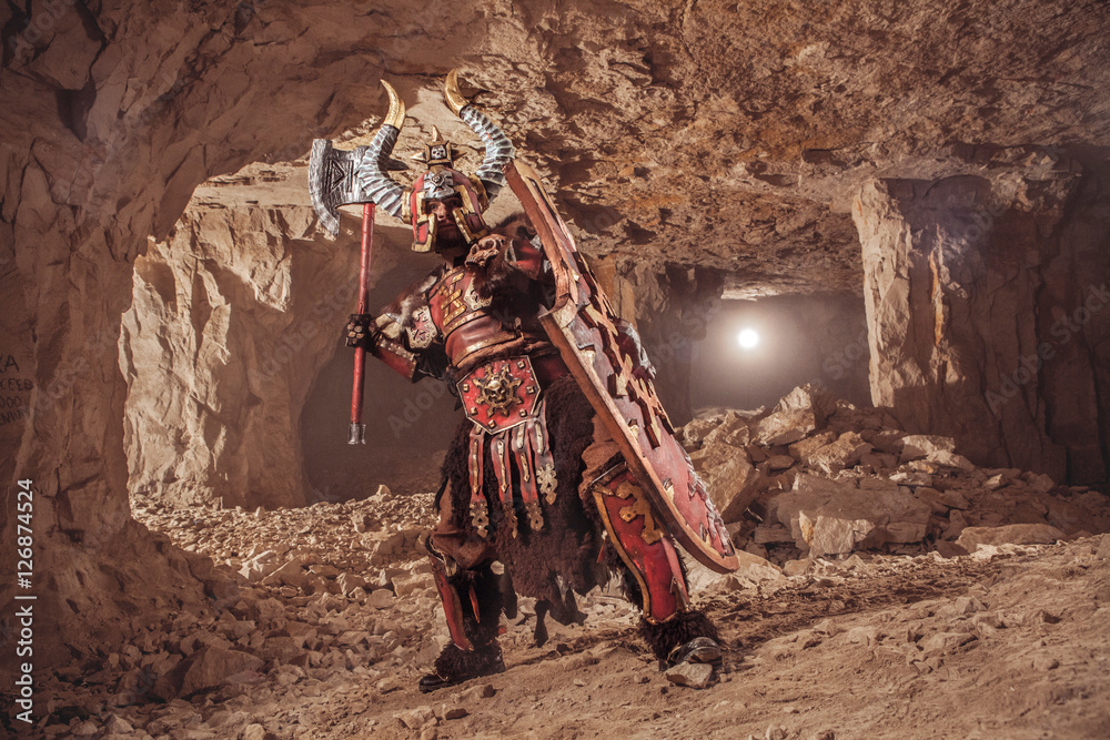 Attack of powerful knight in heavy armor on the dungeon background ...