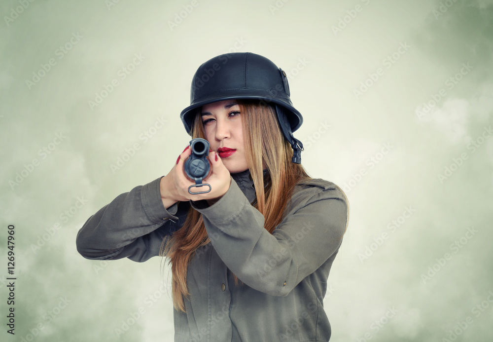 Asian woman in helmet aiming a shotgun at the camera Stock 写真 | Adobe Stock