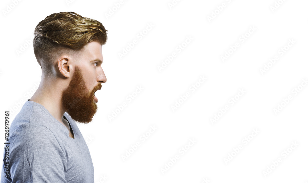Unleashing his emotions. Side view of furious young bearded man ...